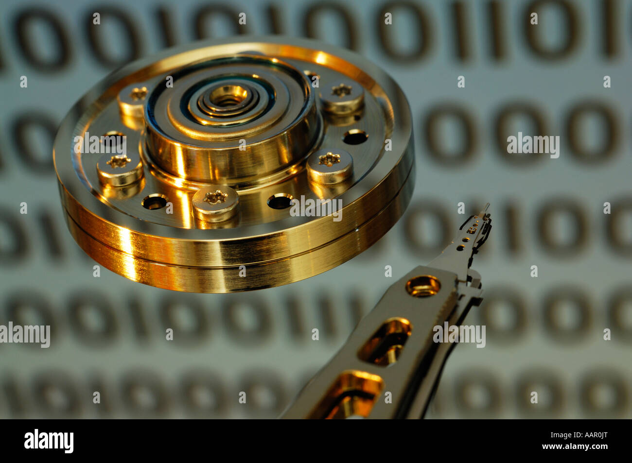 A computer hard disc exposed showing the magnetic disc platter, the ...