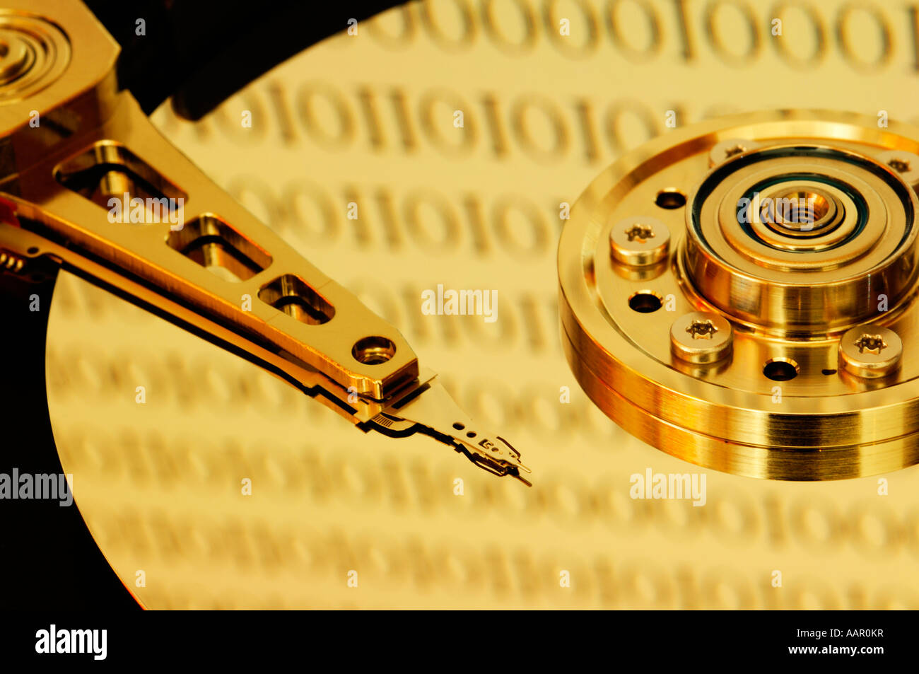 A computer hard disc exposed showing the magnetic disc platter, the read and write head and arm ...