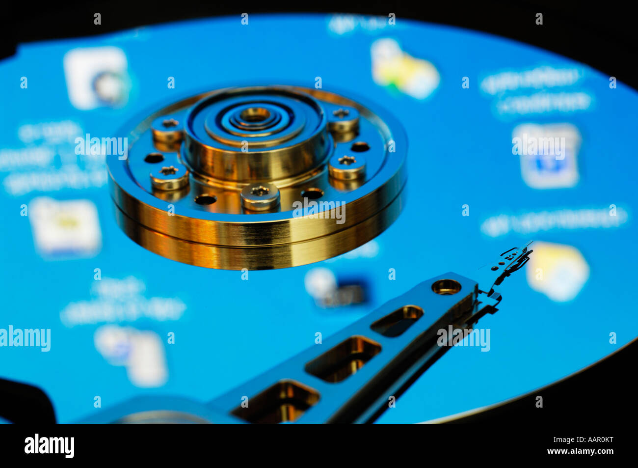 A computer hard disc exposed showing the magnetic disc platter, the ...