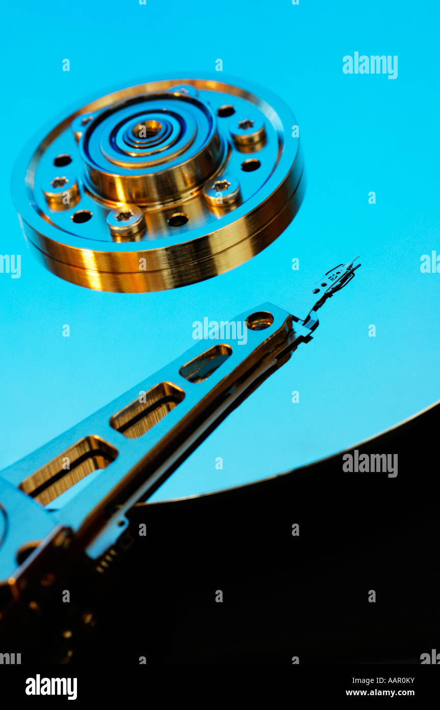 A computer hard disc exposed showing the magnetic disc platter, the ...