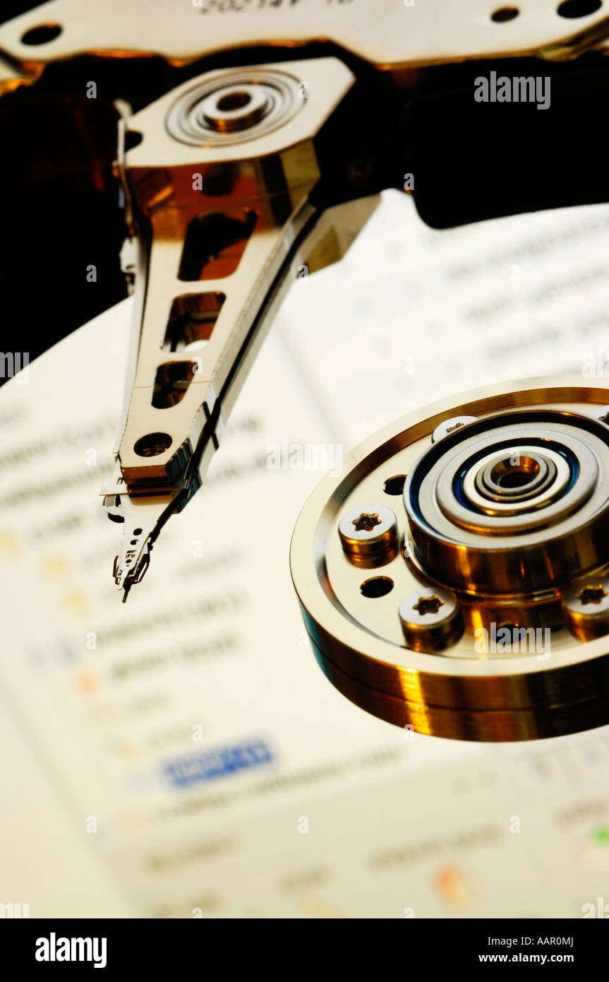 A computer hard disc exposed showing the magnetic disc platter, the ...