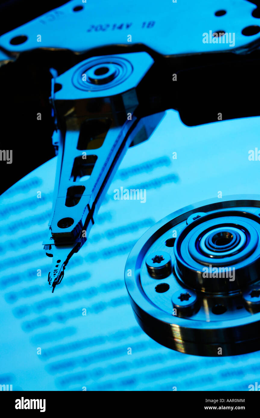A computer hard disc exposed showing the magnetic disc platter, the ...