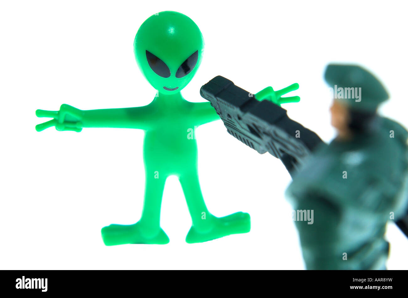 An alien and soldier with arms confront each other Stock Photo - Alamy
