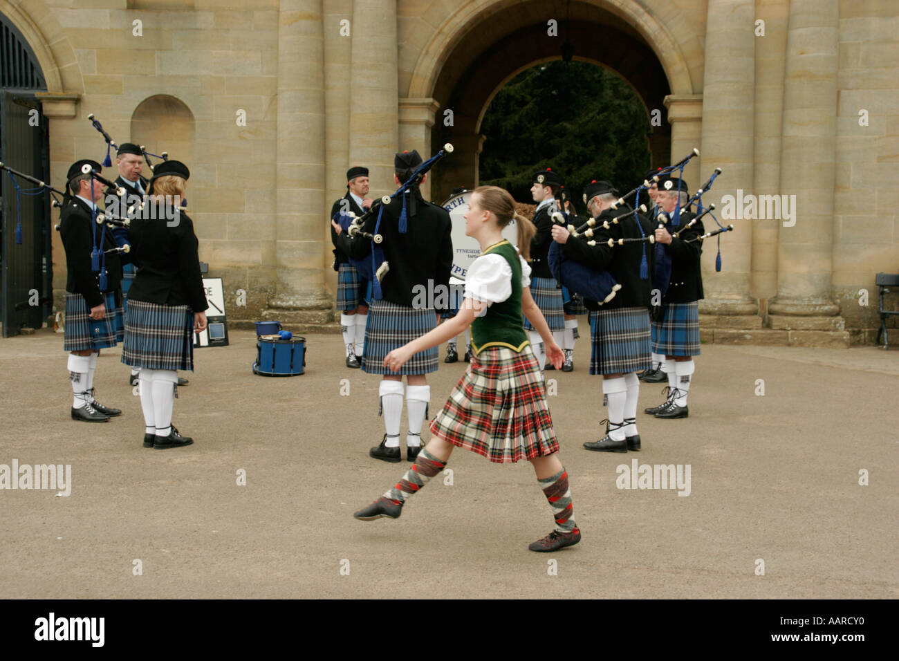 Highland dancer with pipe band Stock Photo - Alamy