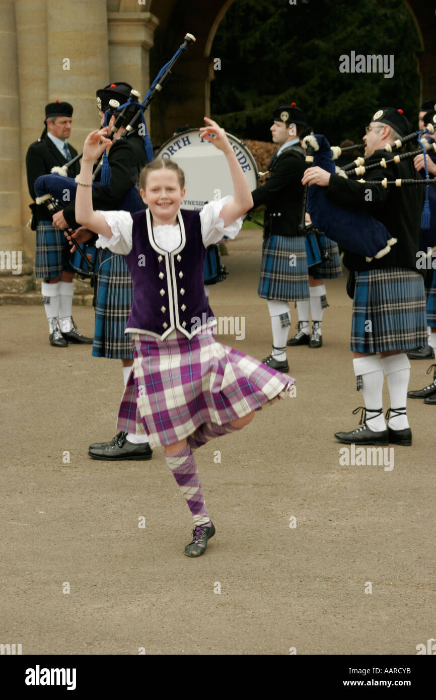 Highland dancer with pipe band Stock Photo - Alamy
