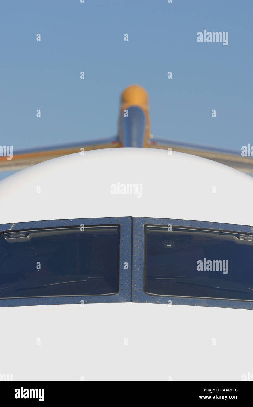 Jet commercial passenger airliner nose on showing cockpit and tail head ...