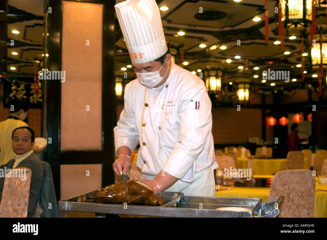 A chef prepares the pecking duck most famous and traditional dish in ...