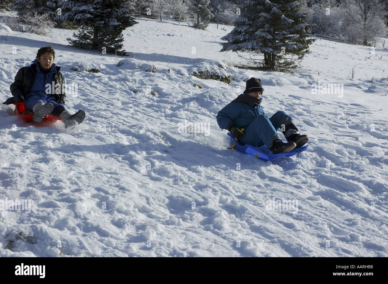 Two Children Sledding Together Stock Photo - Alamy