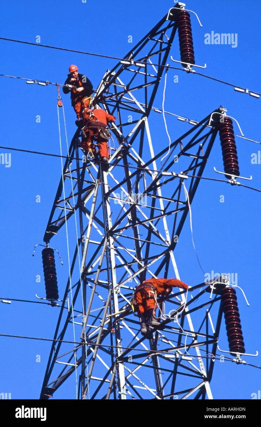 Engineers working on an electricity pylon Stock Photo - Alamy