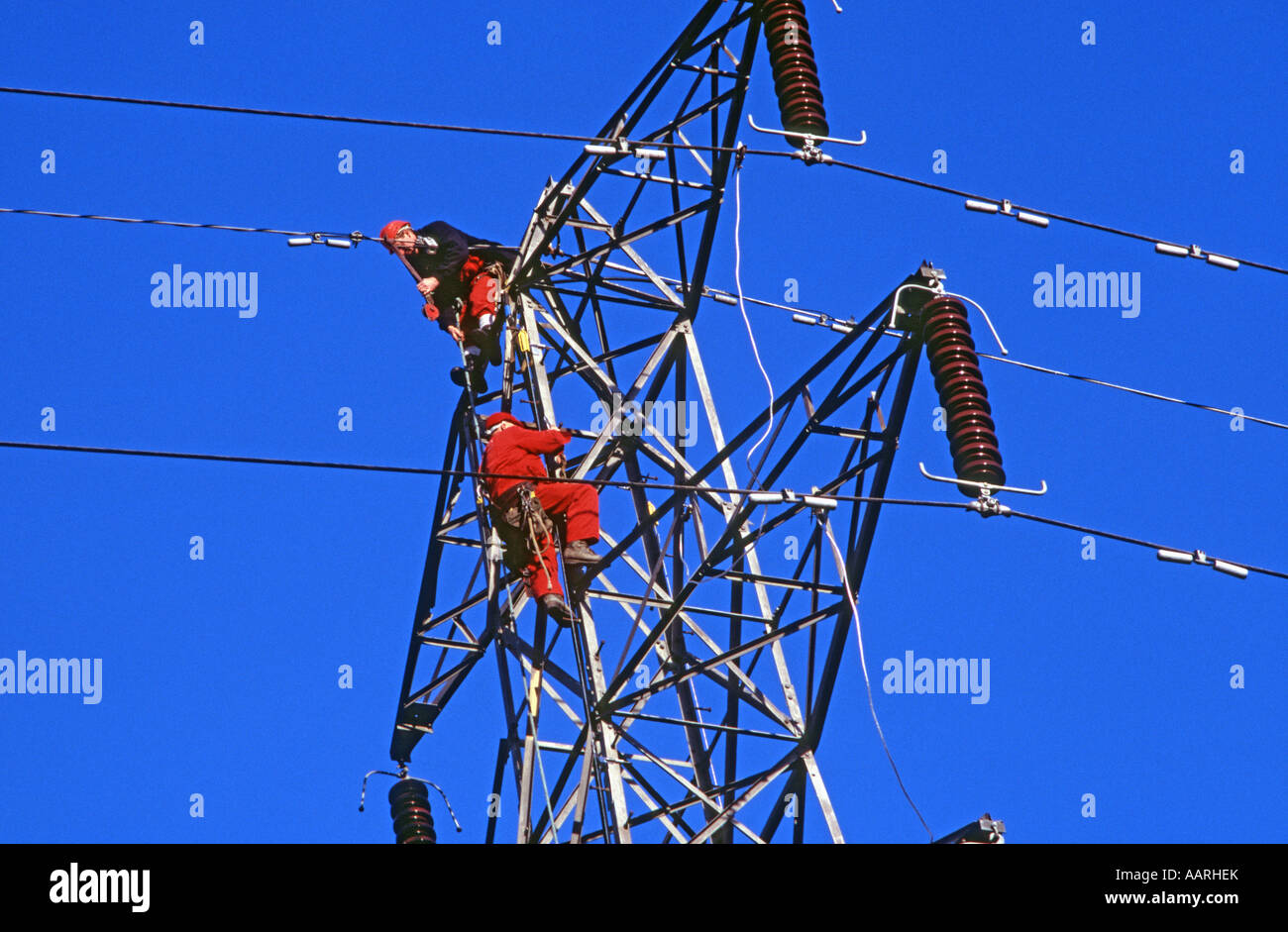 Engineers working on an electricity pylon Stock Photo - Alamy