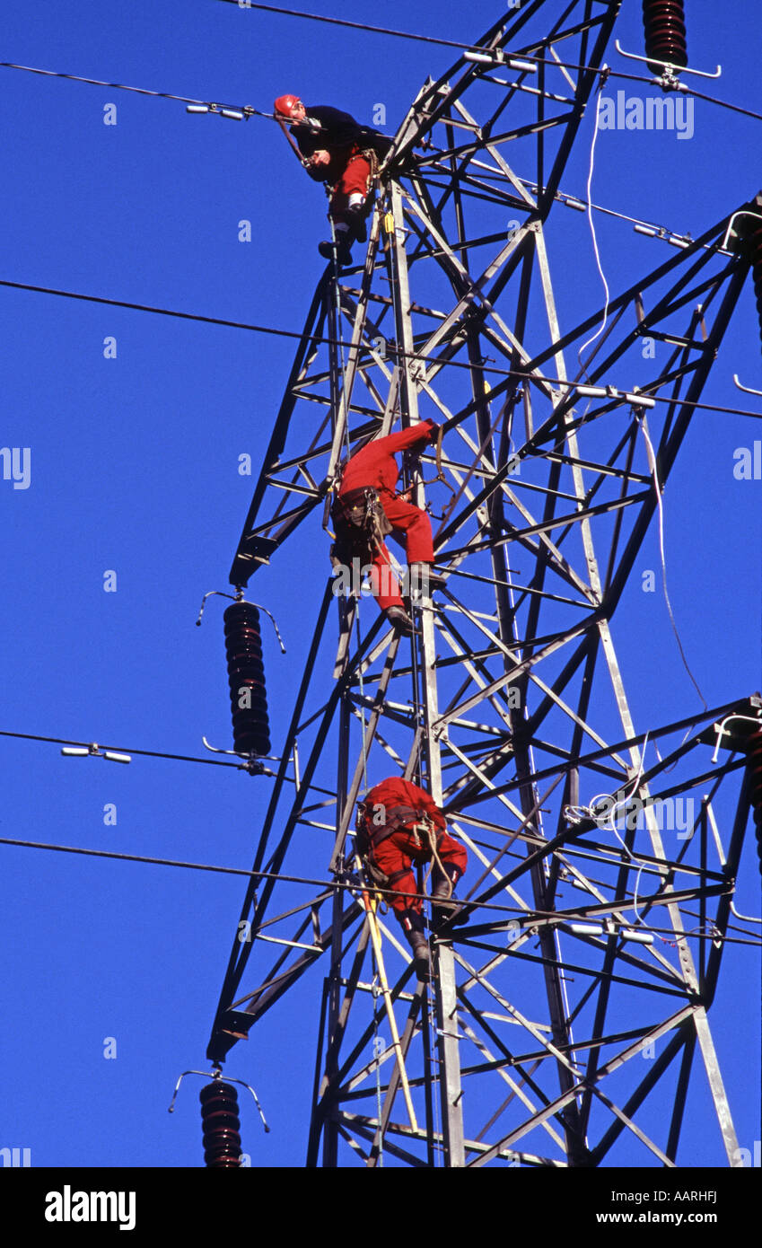 Engineers working on an electricity pylon Stock Photo - Alamy