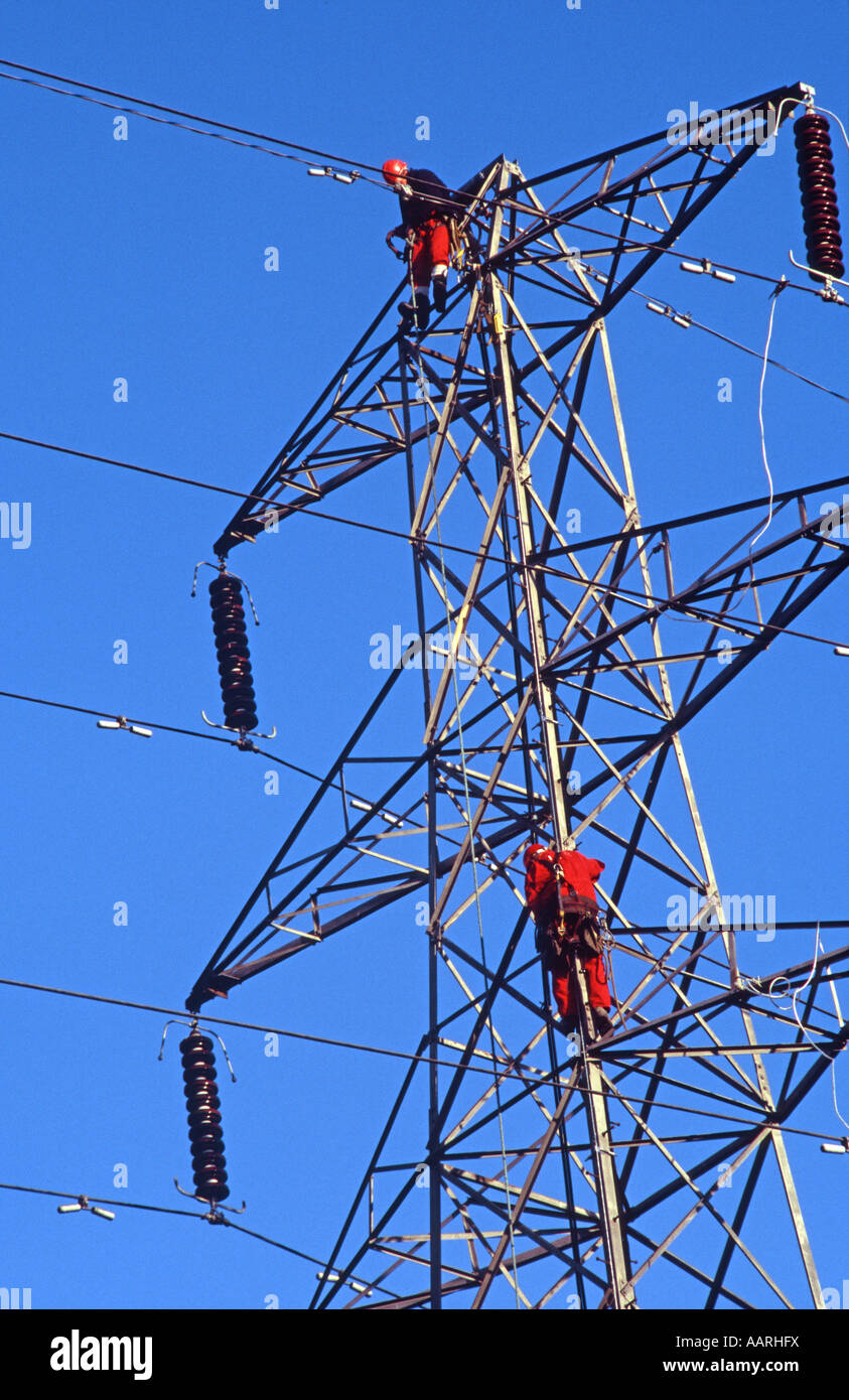 Engineers working on an electricity pylon Stock Photo - Alamy