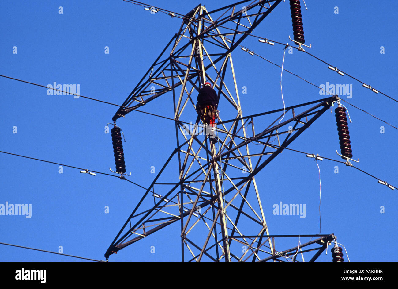 Engineers working on an electricity pylon Stock Photo - Alamy