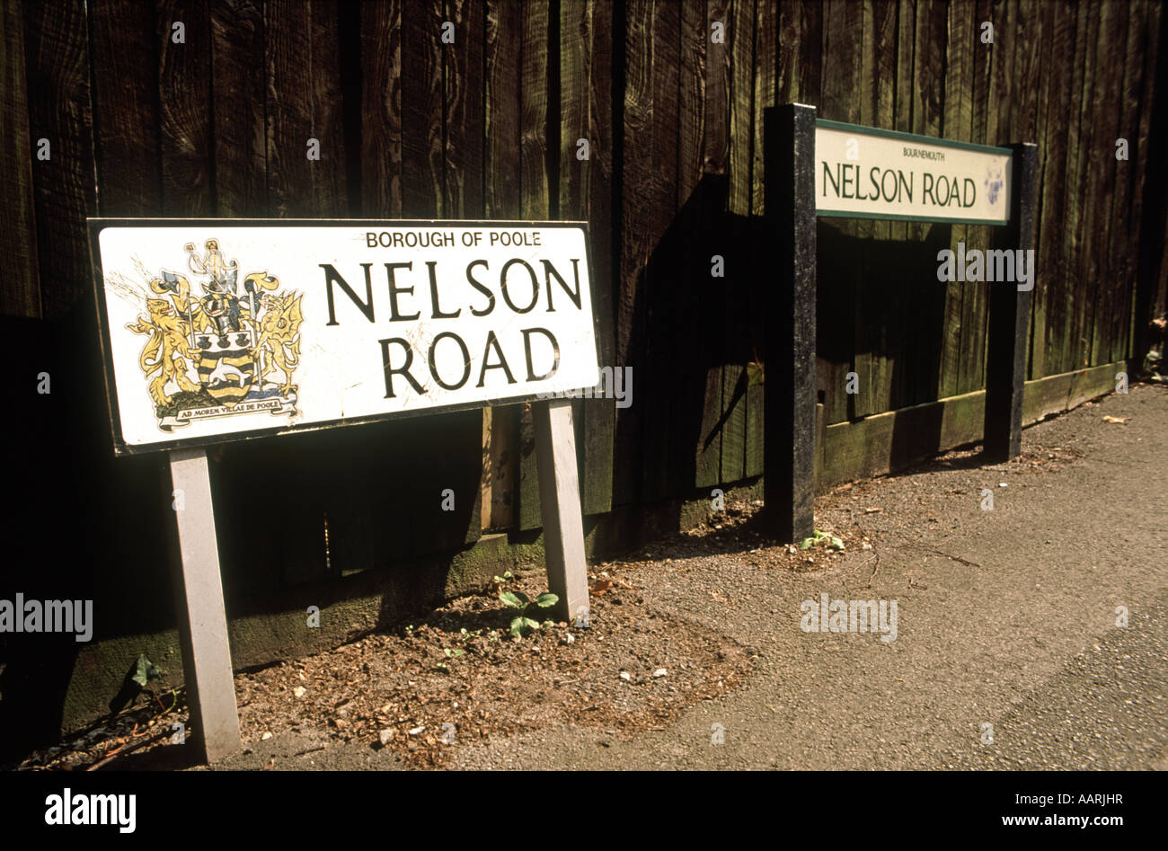 Two road name signs for same road but in adjacent towns Stock Photo - Alamy