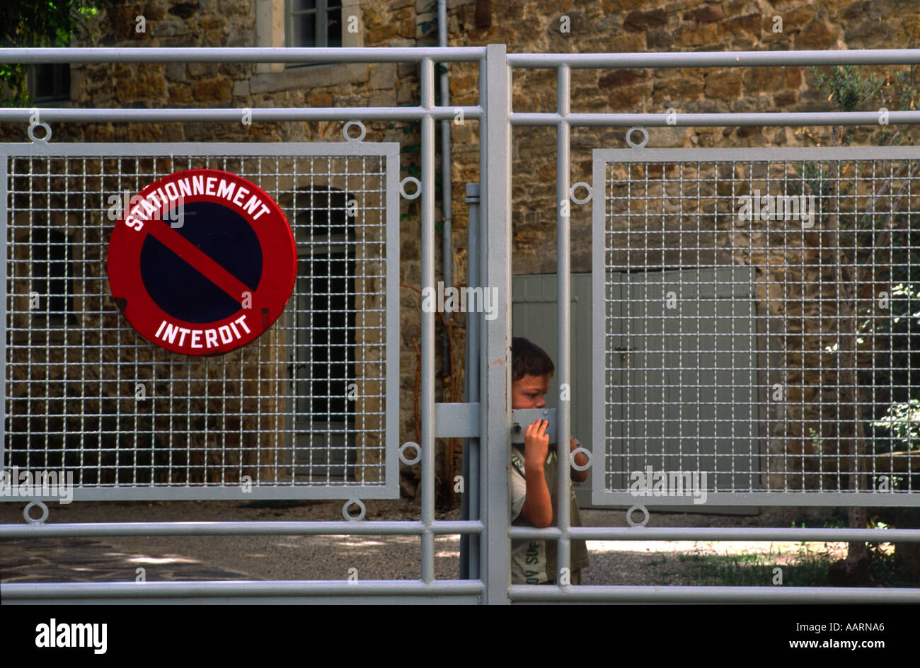 Pensive child at barred gate Aix en Provence Stock Photo - Alamy