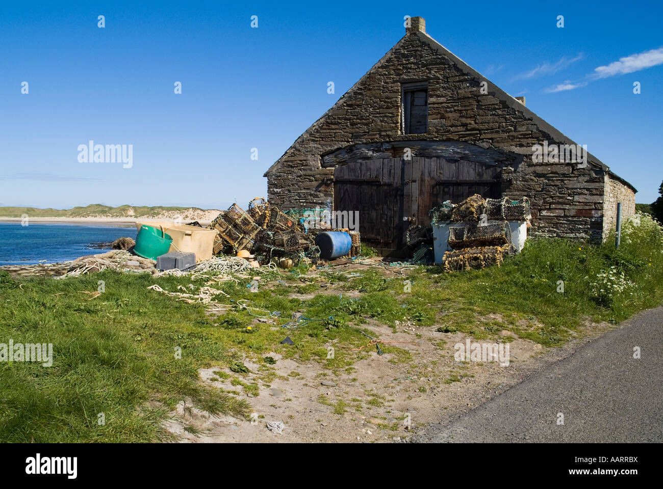 dh Castletown harbour CASTLETOWN CAITHNESS Fishing boatshed with crab ...
