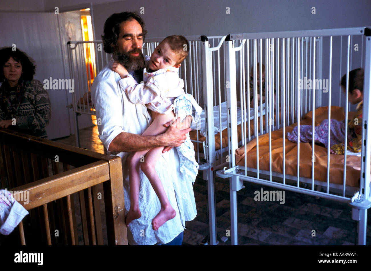 ORPHANAGES IN RUSSIA ORPHANAGE WORKER HOLDS A HANDICAPPED CHILD AT ...
