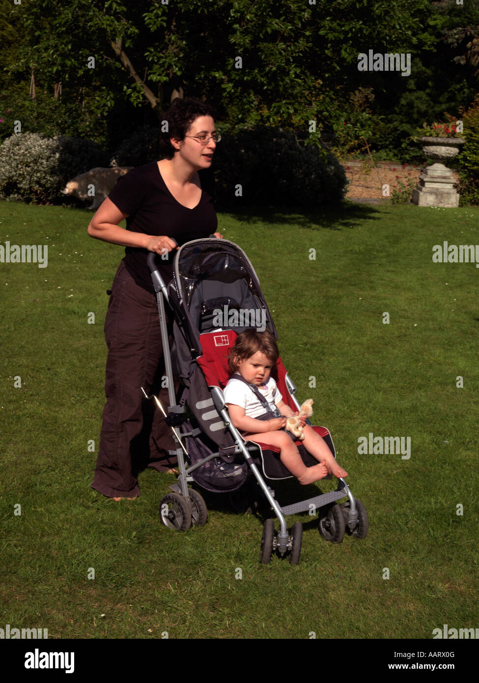 Mother Pushing Pushchair Stock Photo - Alamy