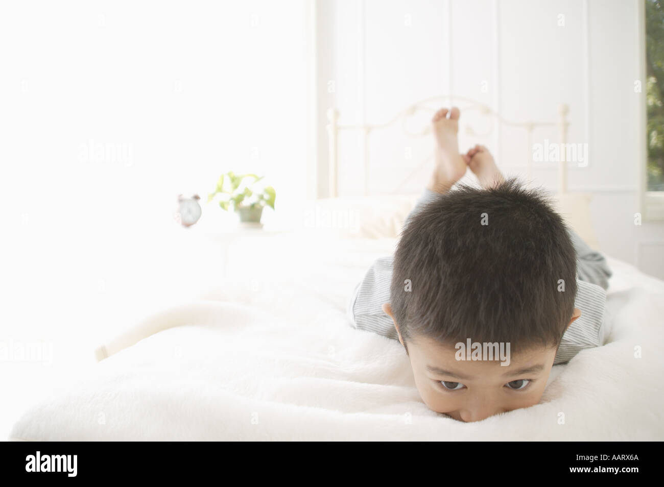 A boy lying on bed Stock Photo - Alamy