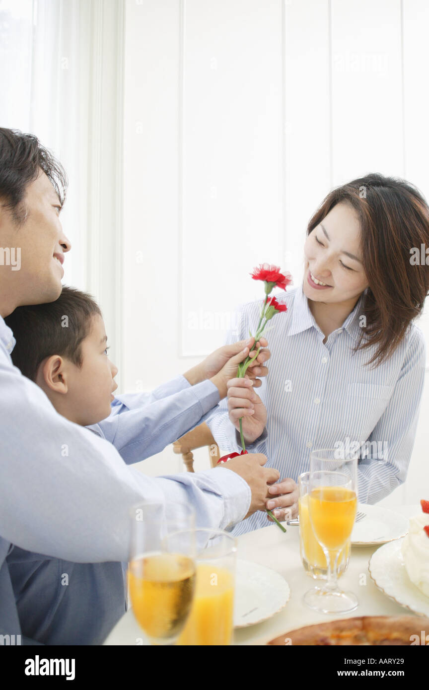 Man giving flower mother smiling hi-res stock photography and images ...