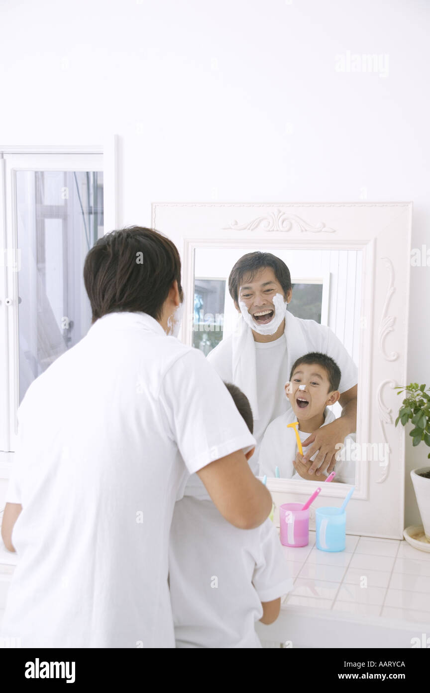 Father shaving with son standing beside Stock Photo - Alamy