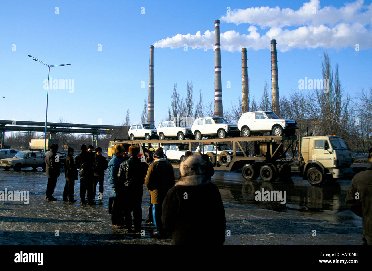 LADA OUTSIDE THE FACTORY WORKERS FILE PAST A TRUCK LOADED WITH NEW ...