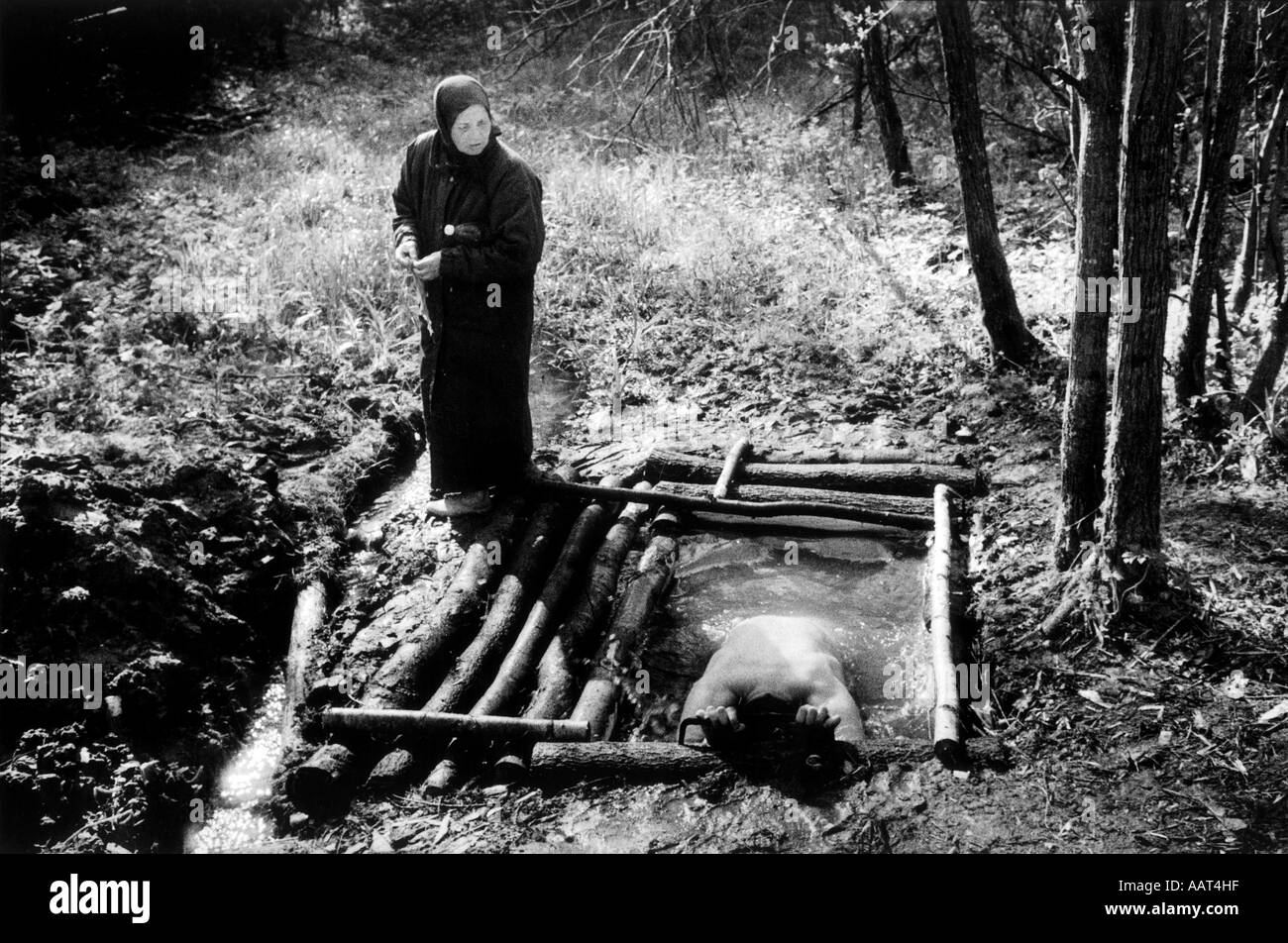 A Russian pilgrim immerses himself in a holy spring during a pilgrimage ...