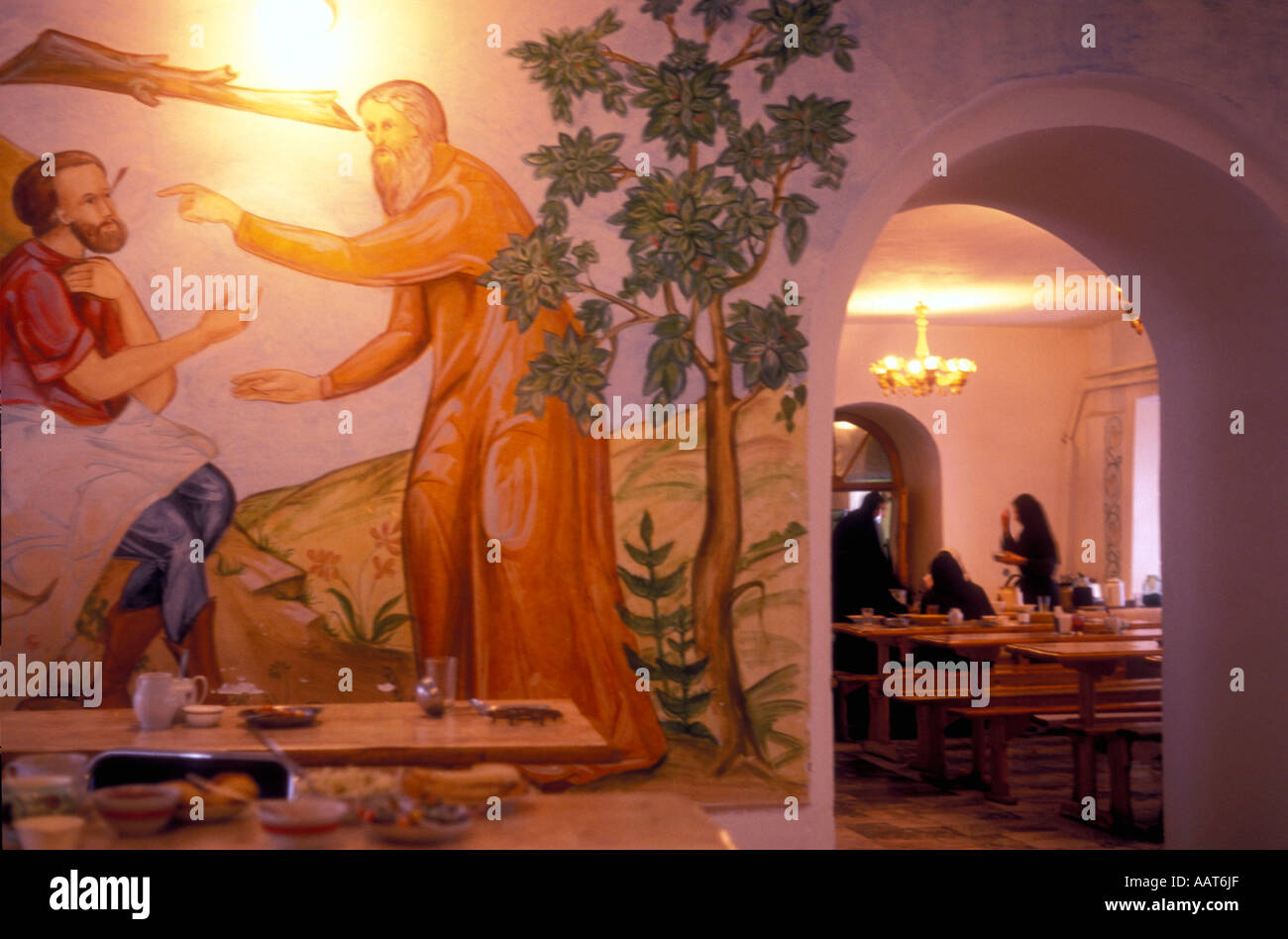Nuns praying before the evening meal in the refectory of a Russian ...