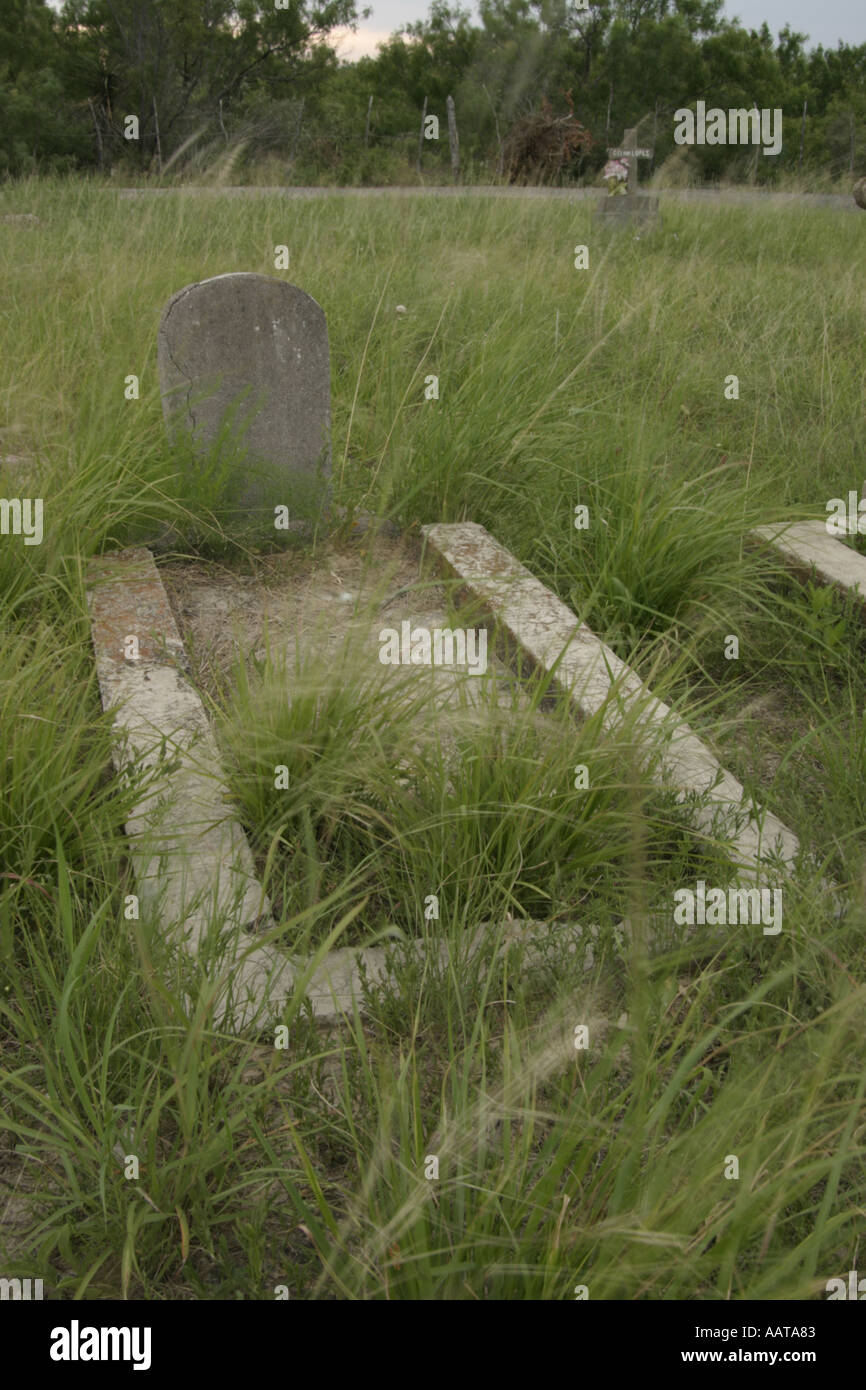 Old grave overgrown with grass Stock Photo - Alamy