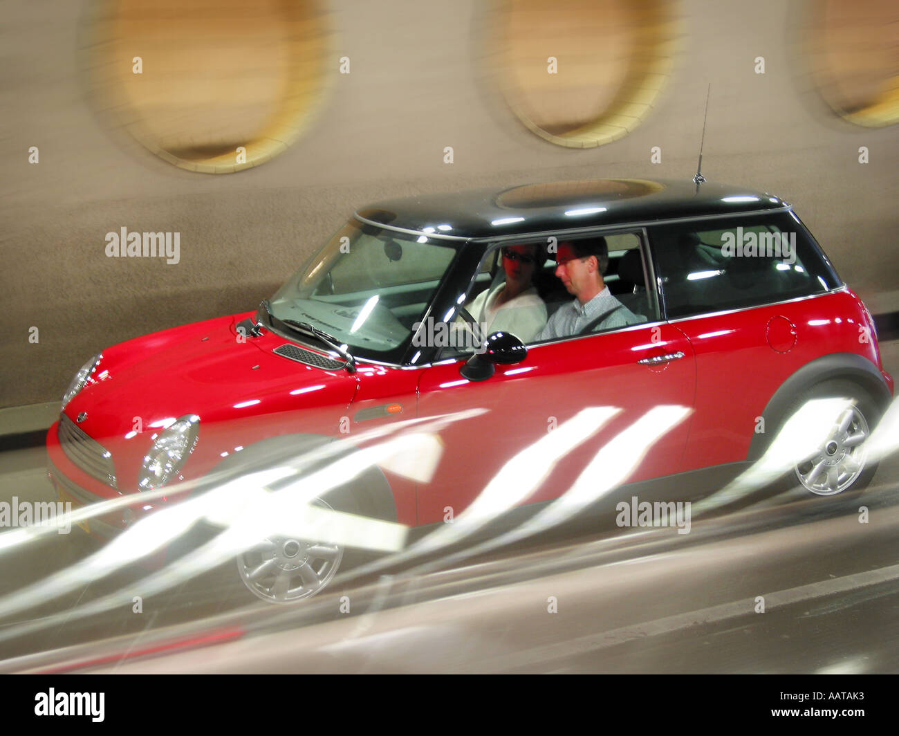 new Mini Cooper saloon red with black roof driving through tunnel Stock ...