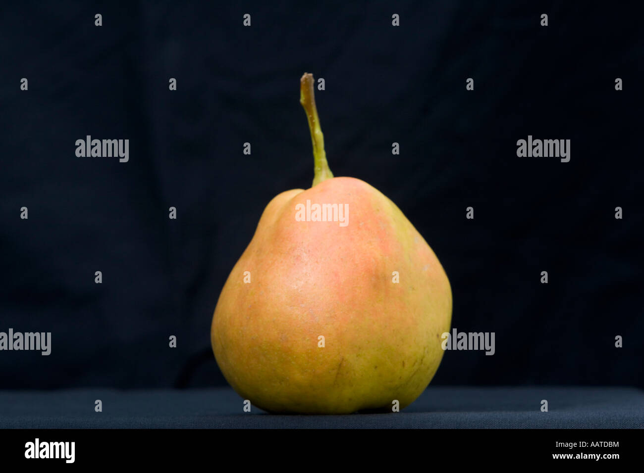 Organic comice pear (Pyrus communis) isolated on black background Stock ...
