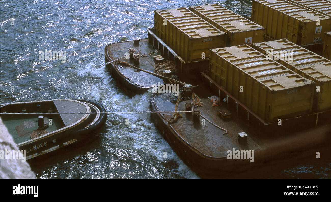 tug boat pulling two barges on River Thames Stock Photo - Alamy