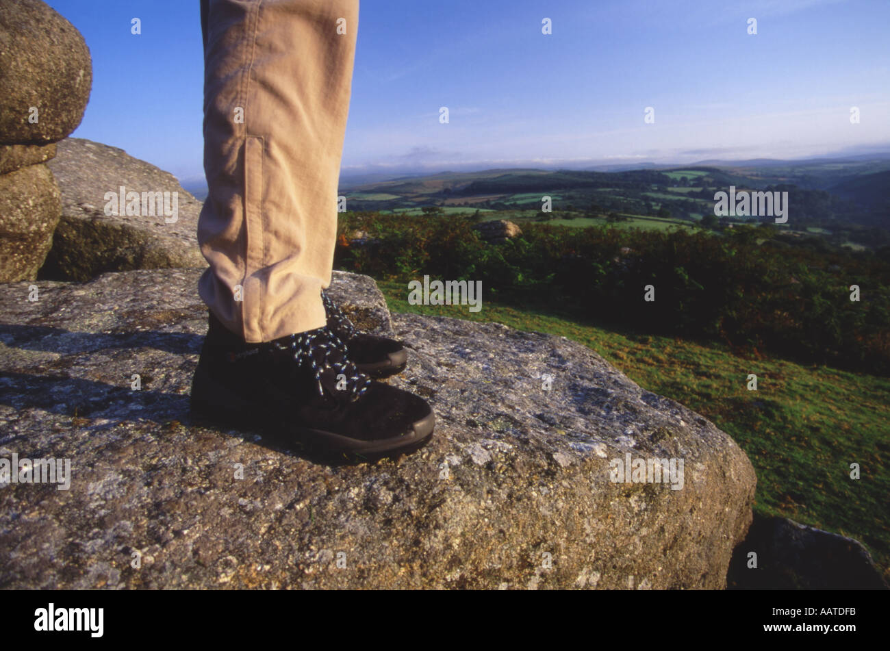 Walkers legs stood on rock Combestone Tor Dartmoor Devon UK Stock Photo ...