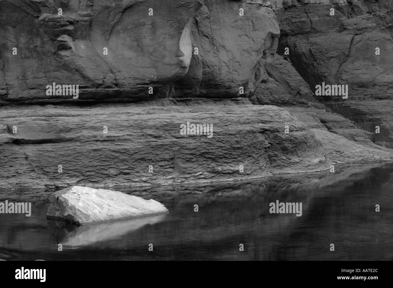 White rock in stream in front of rock formation Stock Photo - Alamy