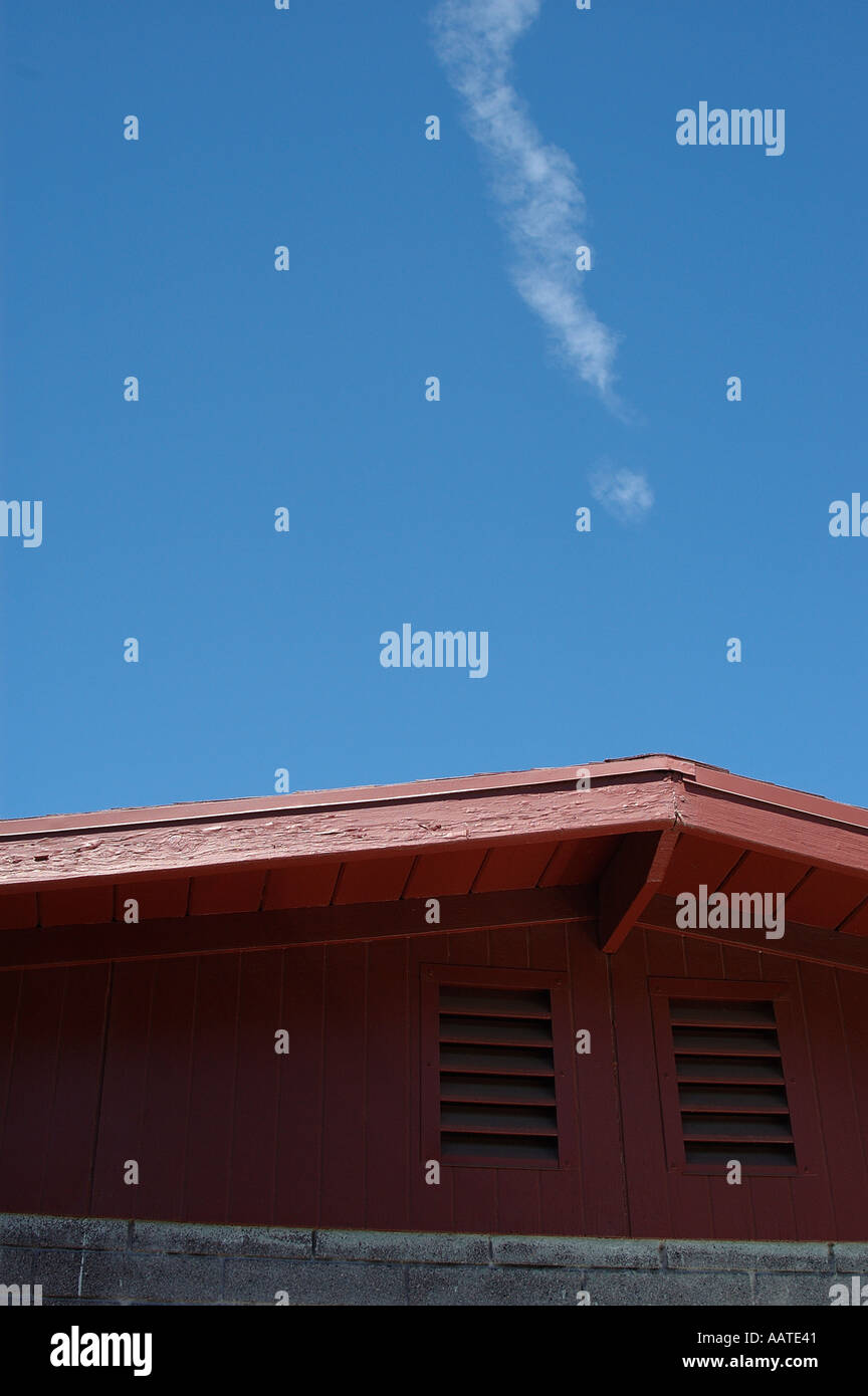 Roofline of house with red eve and blue sky above Stock Photo - Alamy