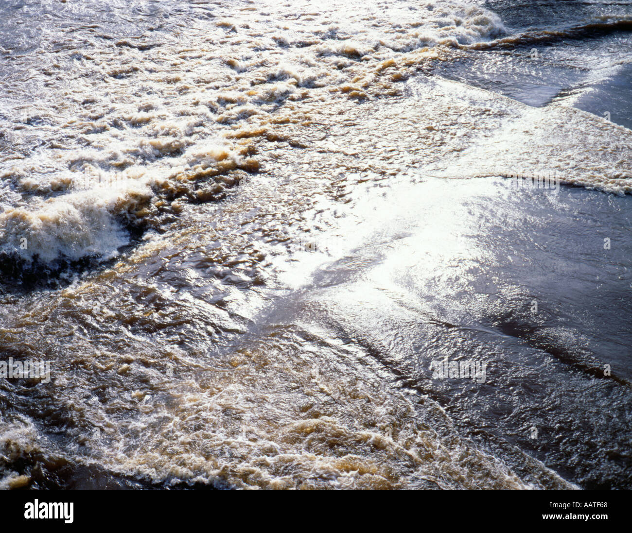 Flood water flowing over an apron; River Tyne in flood beneath the Tyne ...