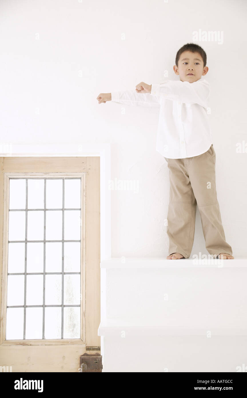 Boy standing on steps Stock Photo - Alamy