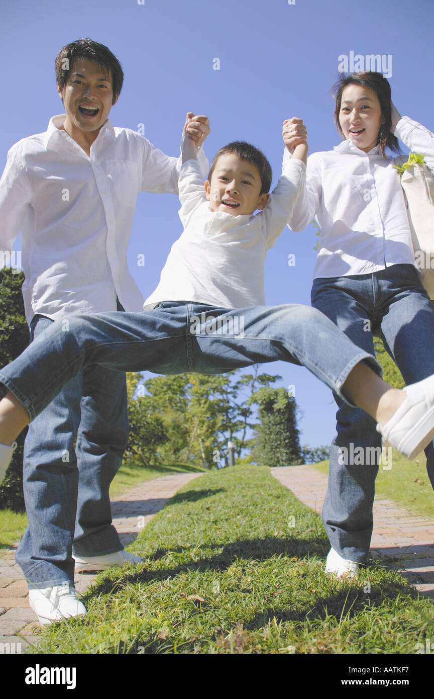 Parents lifting son Stock Photo - Alamy