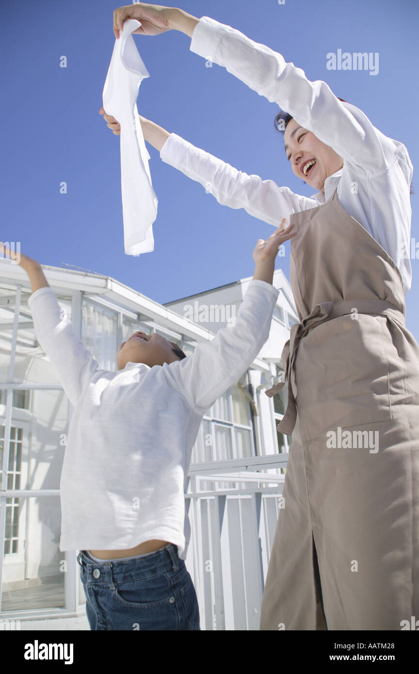 Mother and son doing laundry Stock Photo - Alamy