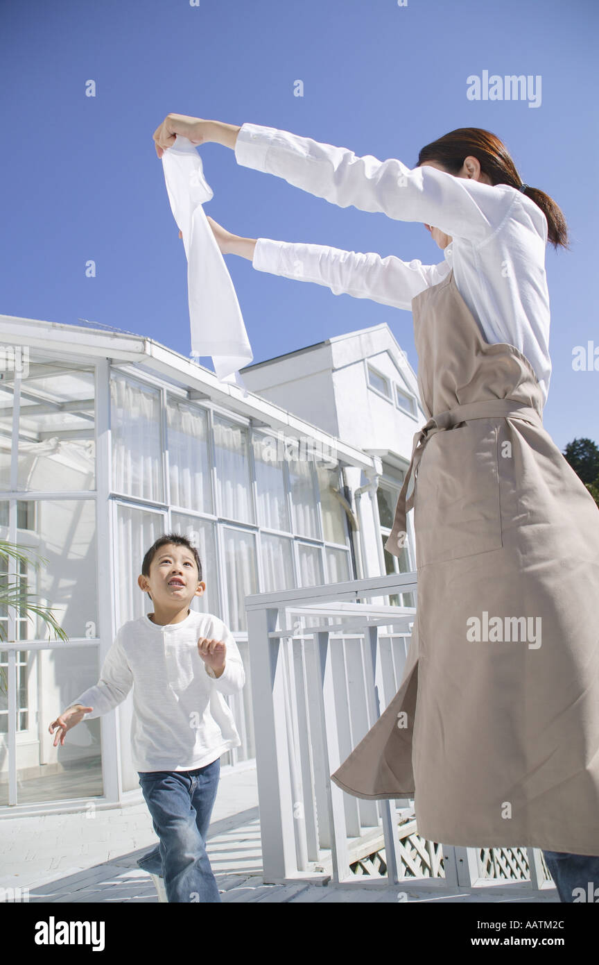 Mother and son doing laundry Stock Photo - Alamy
