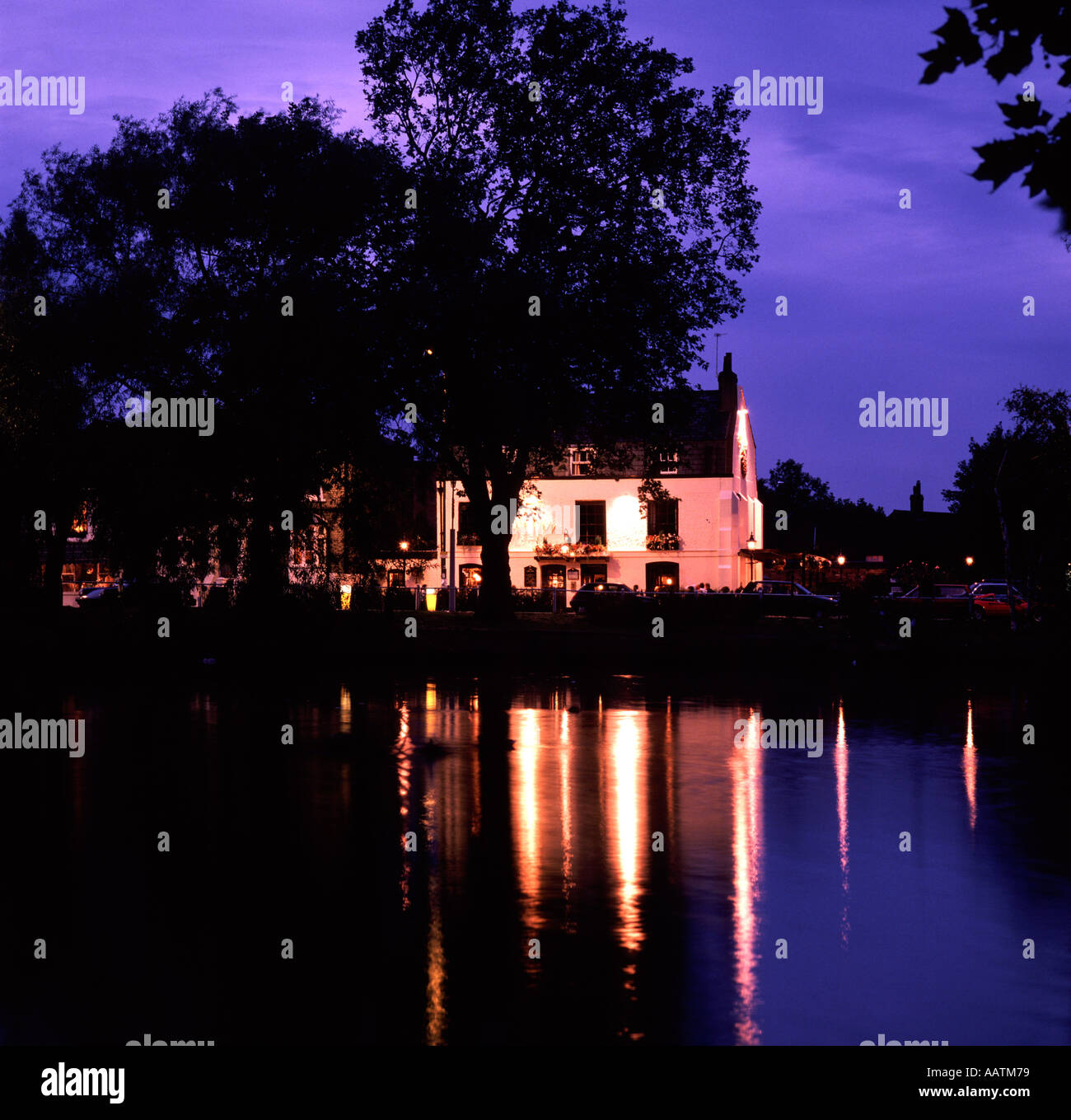Reflection of a British pub in a pond at dusk Stock Photo - Alamy