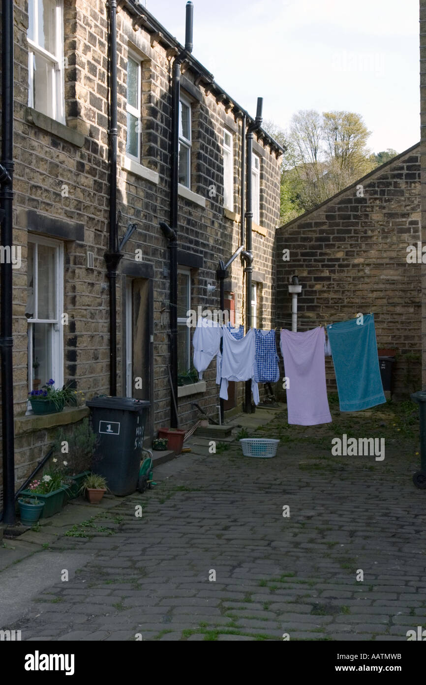 Washing hung out on washing line outside typical terraced street with ...