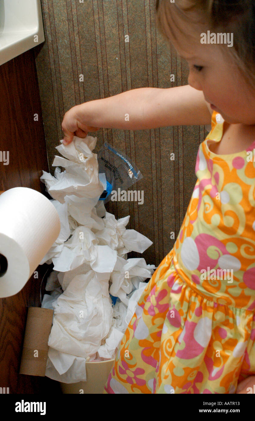 Child with disgusting overflowing trash can Stock Photo - Alamy