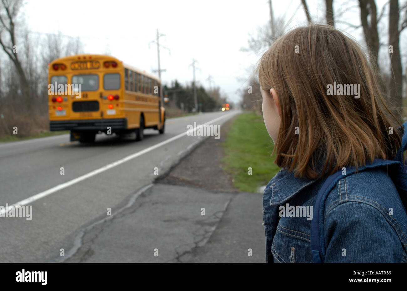 Child waiting for bus Stock Photo - Alamy