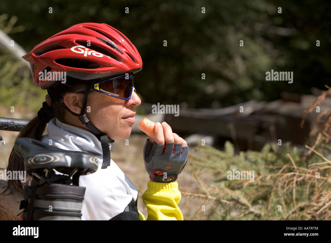 Young woman cyclist eating Stock Photo - Alamy