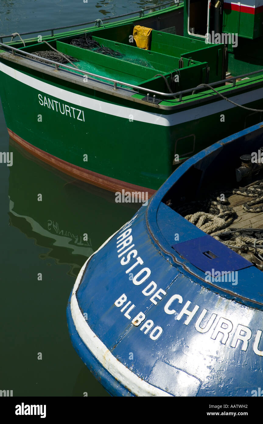 Sterns of red and green fishing trawlers, Santurtzi, Pais Vasco, Spain ...