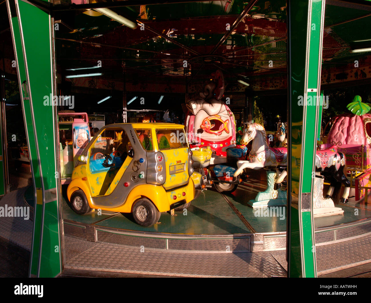 yellow car on children s merry go round Stock Photo - Alamy