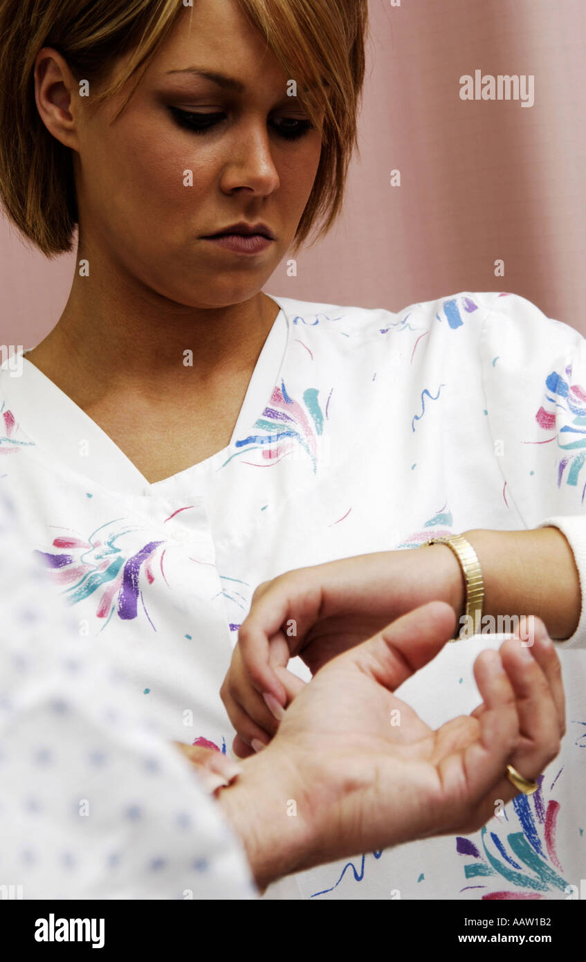 Nurse checking patients pulse Stock Photo - Alamy