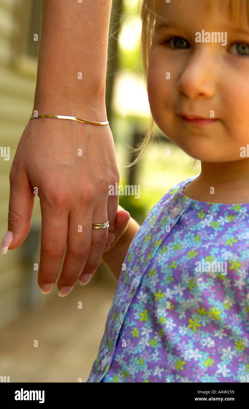 Girl holding womans hand Stock Photo - Alamy