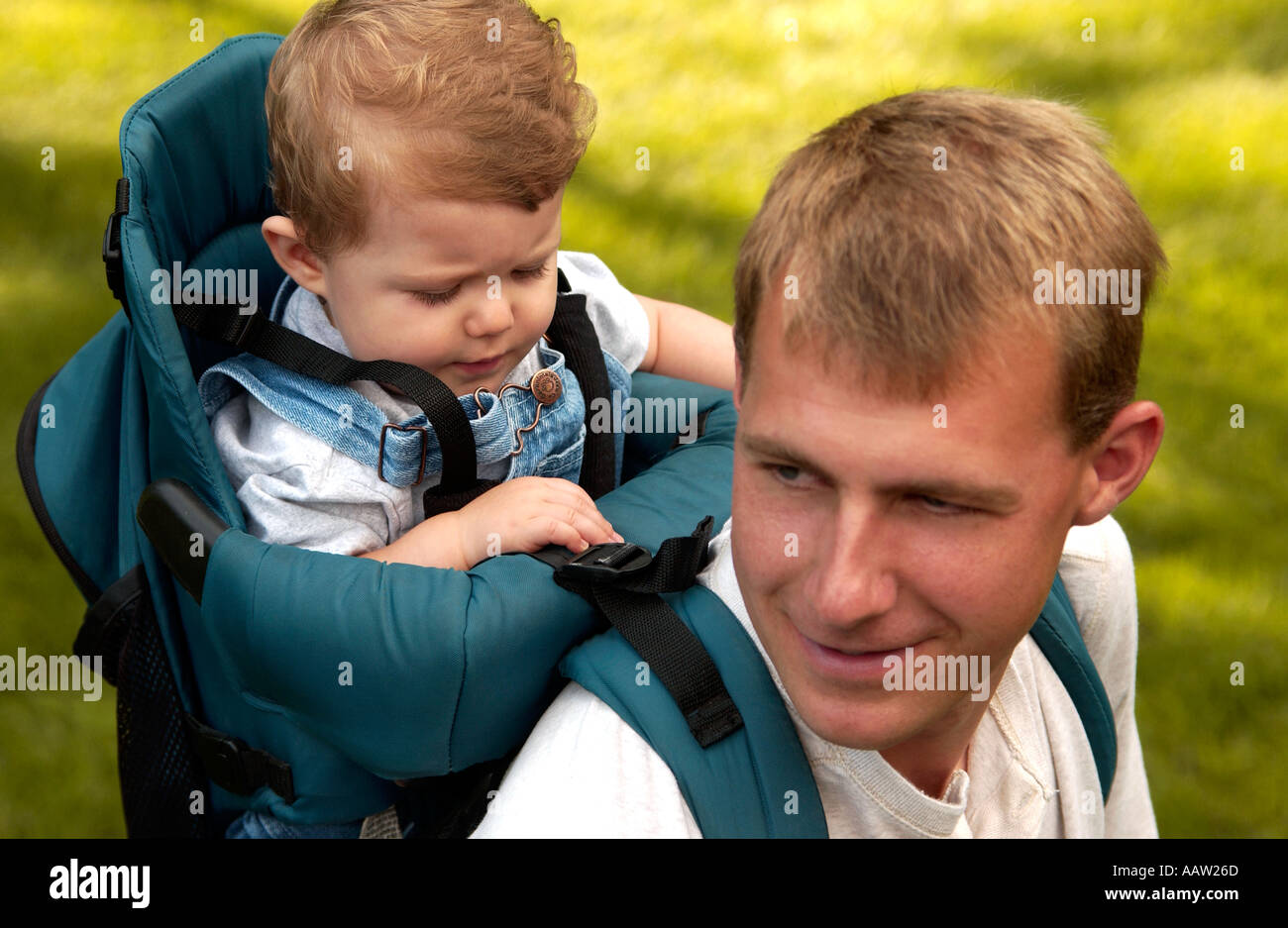 Father carrying son in backpack hiking on walk Stock Photo - Alamy